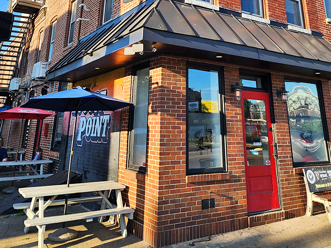 The red door and outdoor picnic tables say it all: "Come as you are, leave with Old Bay under your fingernails."