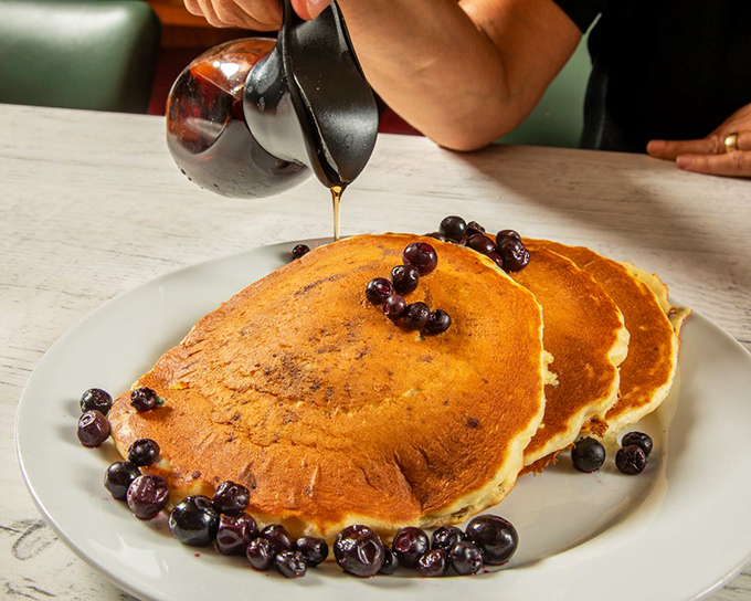 These pancakes aren't just breakfast, they're edible sunshine topped with blueberries and waiting for that perfect maple syrup waterfall.