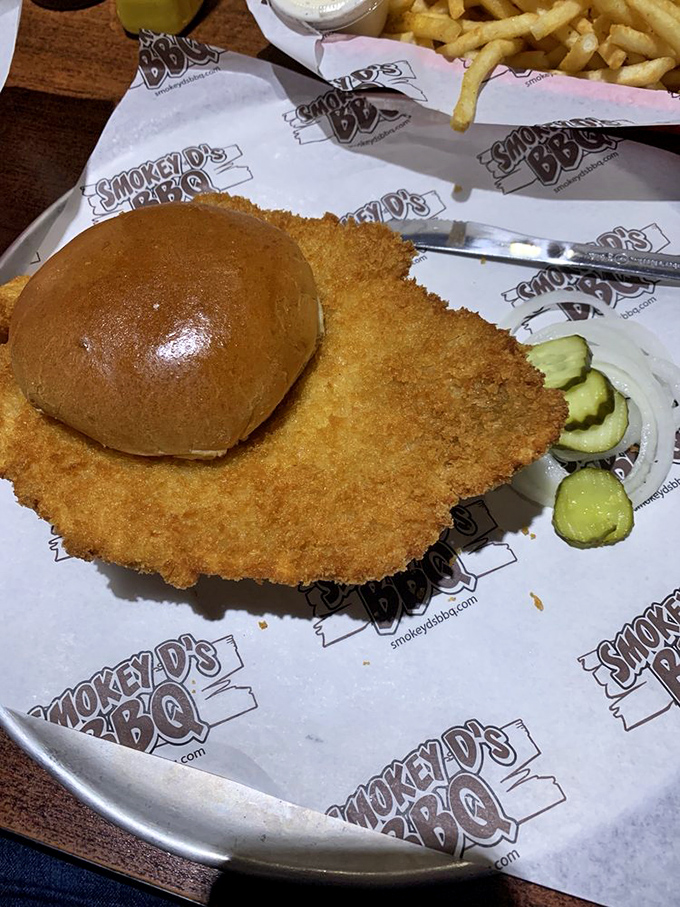 The pork tenderloin sandwich that makes Iowa famous &ndash; golden-fried to perfection and hanging off the plate like a crispy badge of honor.