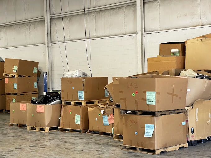 Supply chain, Goodwill style. These cardboard towers contain tomorrow's treasures, waiting for their turn in the spotlight of the sales floor.
