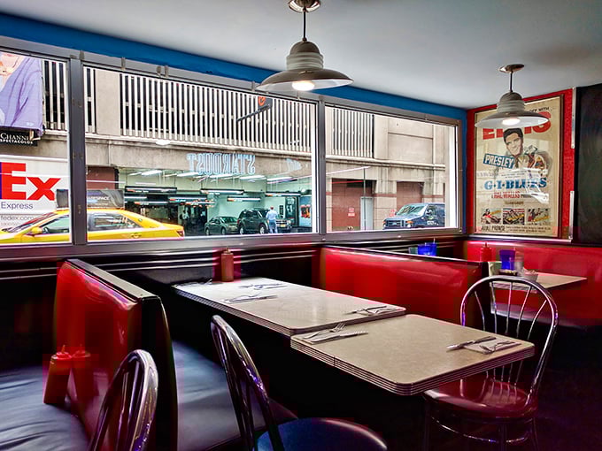 Red booths frame the windows like theater boxes, offering glimpses of the city while vintage posters remind you of entertainment's golden age.