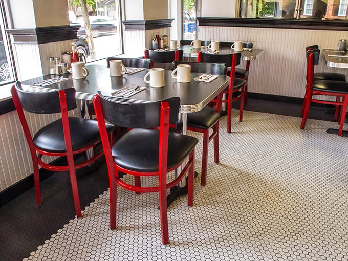 These tables have heard more Boston stories than a bartender at Cheers, while those red chairs have cradled generations of satisfied diners.