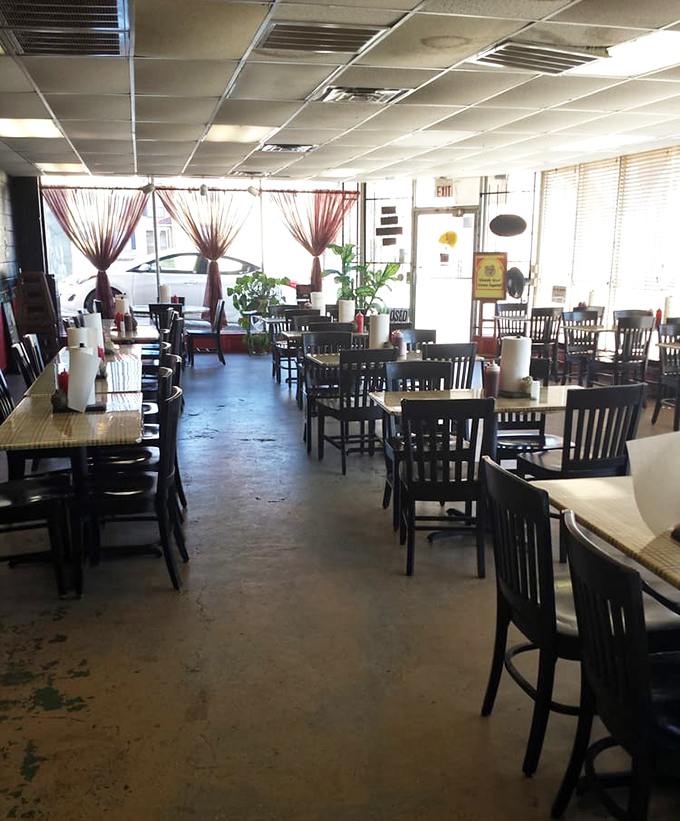 Empty tables waiting for the lunch rush like blank canvases before an artist arrives. The curtains add a touch of "we care" to a place that's all about the meat.