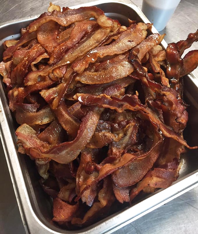 The counter seating – where solo diners become regulars and the coffee refills flow as freely as the local gossip.