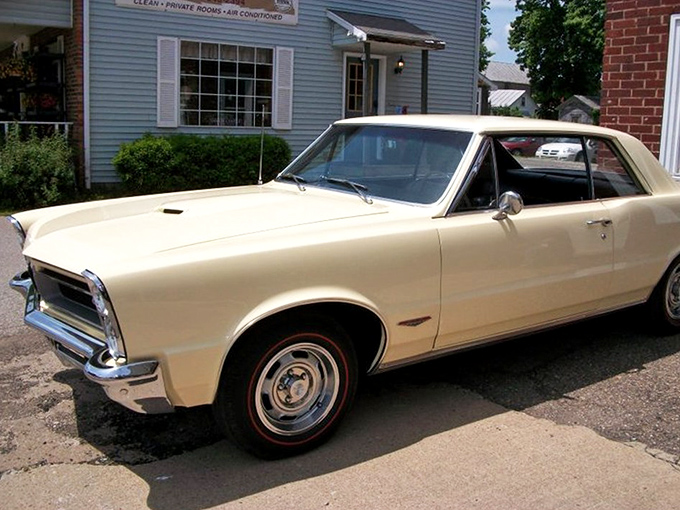 The elegant cream-colored 1965 Pontiac GTO represents the birth of the muscle car era&mdash;when Detroit discovered that performance sells.