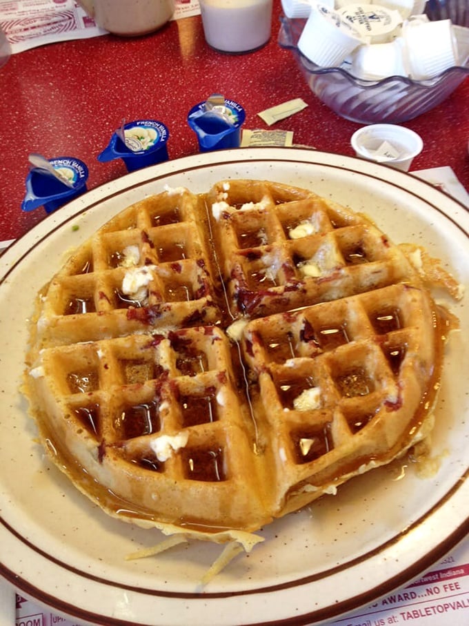 This waffle isn't just breakfast &ndash; it's a golden grid of possibility, waiting for maple syrup rivers to flow through its perfect valleys.