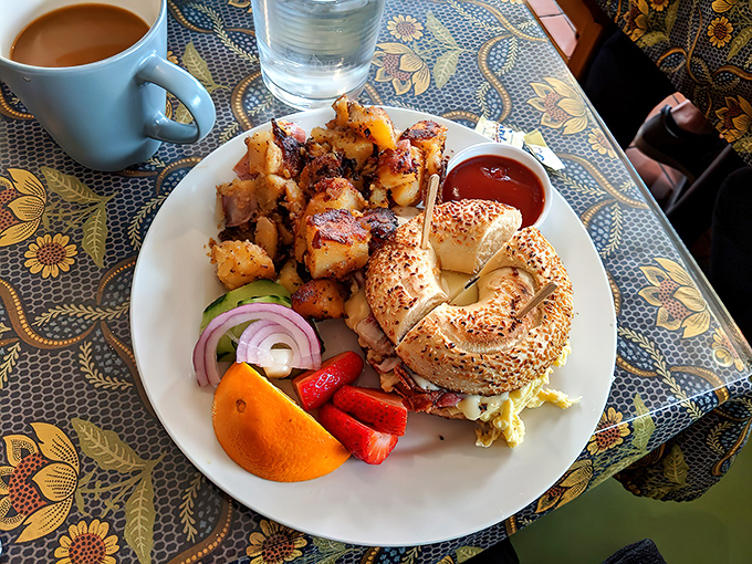 A bagel sandwich that makes New Yorkers momentarily question their loyalty, surrounded by potatoes that seal the deal.