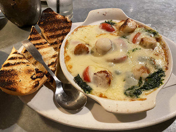 These baked scallops in their bubbling cheese bath might make you forget your table manners. Nobody will judge you.