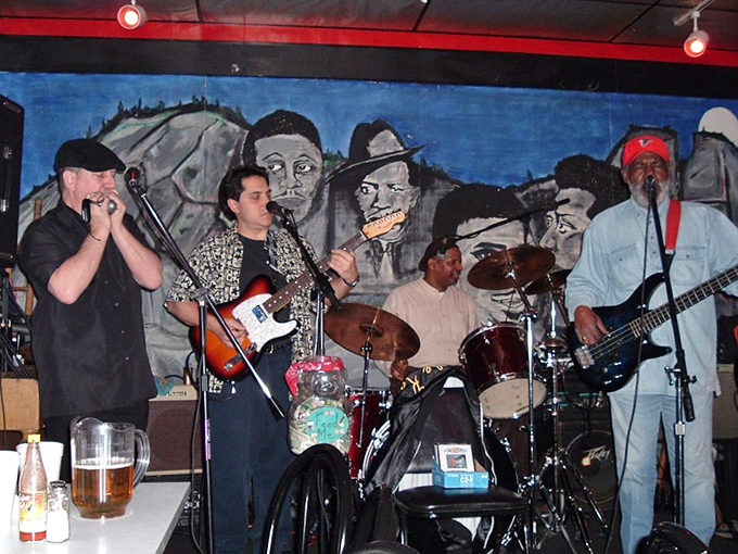 The blues band doesn't just play music—they provide the soundtrack to your spiritual barbecue awakening. Napkins double as handkerchiefs for happy tears.