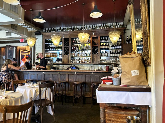 The bar beckons with bottles arranged like soldiers ready for duty. Wine glasses hang in anticipation of the evening's celebrations.