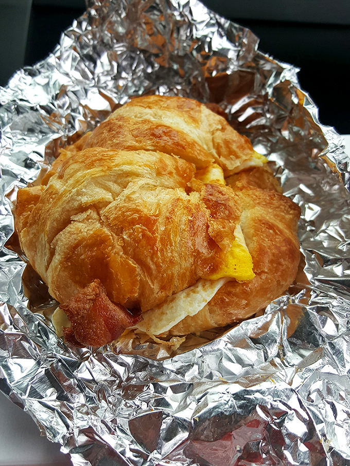 This breakfast sandwich on a croissant isn't just food - it's edible architecture wrapped in buttery, flaky perfection. 