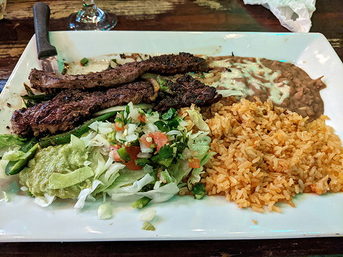 Perfectly grilled carne asada that would make a vegetarian consider a career change, served with all the proper accompaniments.