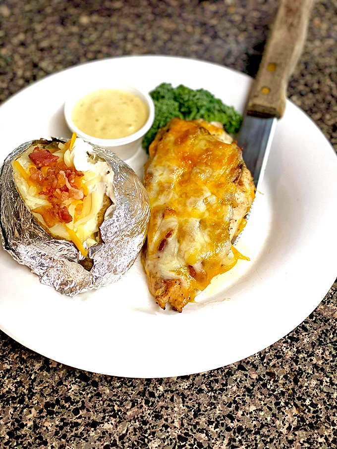 A perfectly baked chicken breast and loaded potato that proves Fisherman's Cove isn't just about seafood – they're equal opportunity comfort providers.