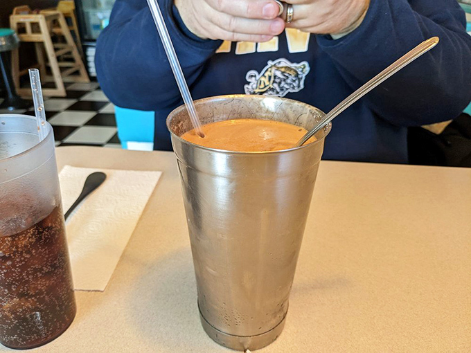 Milkshake perfection in its natural metal habitat. The spoon standing at attention in this thick concoction tells you everything you need to know.