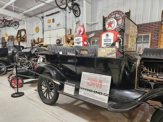 This Model T isn't just a car; it's the great-grandfather of everything on the road today, displayed alongside vintage gas pumps that once fueled America's love affair with the open road.