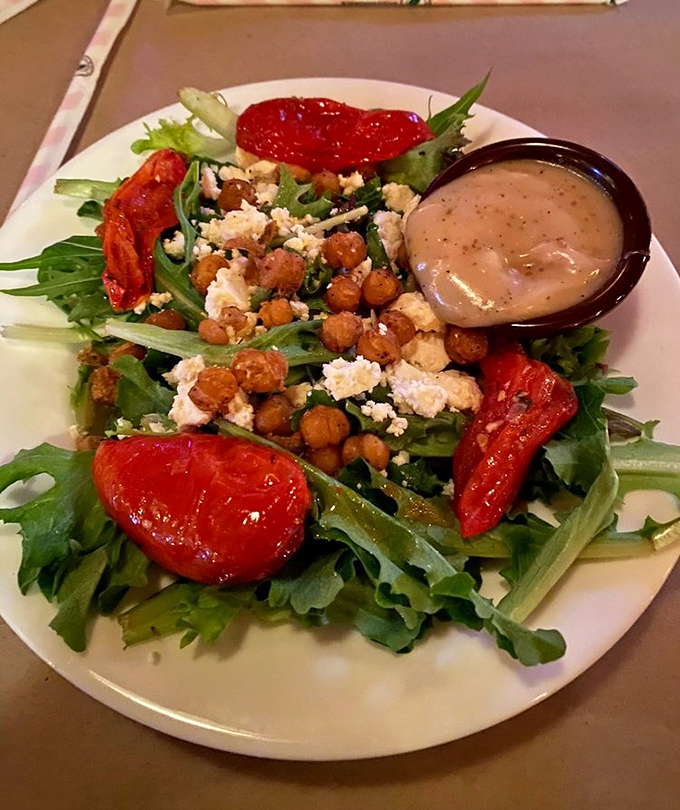 A salad that doesn't apologize for being a salad. Those roasted tomatoes and crispy chickpeas are staging a vegetable revolution.
