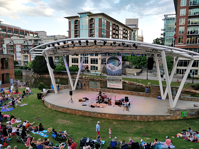 Riverside concerts under summer skies where strangers become neighbors and music floats across the water like an invitation to joy.