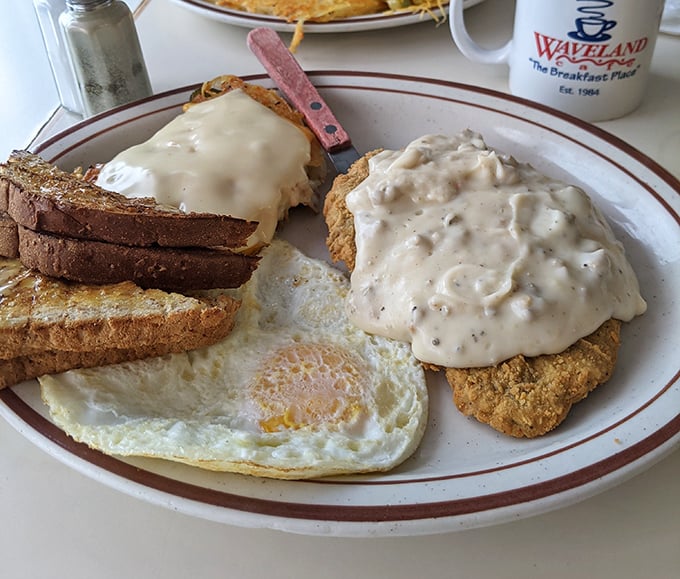 Biscuits swimming in gravy with a perfectly fried egg—the breakfast equivalent of winning the lottery on a Tuesday.