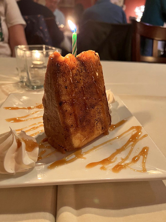 A birthday dessert that makes candles nervous with its caramelized top. This isn't just cake—it's a warm hug on a plate.