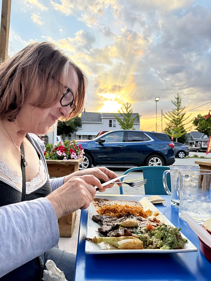 The universal expression of "first bite bliss" knows no language barriers. Those sunset colors in the background can't compete with what's on her plate.