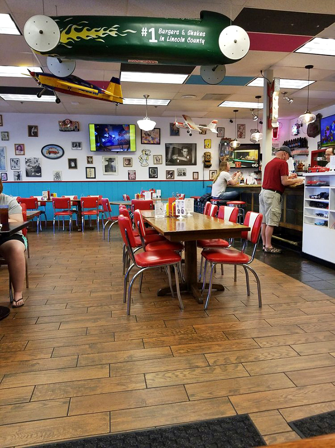 The torpedo overhead proclaims "#1 Burgers & Shakes in Lincoln County." With those cherry-red chairs and memorabilia-covered walls, who's arguing?