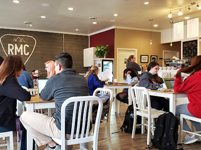 The modern coffee shop tribal gathering &ndash; laptops open, conversations flowing, everyone silently agreeing this is better than their office.