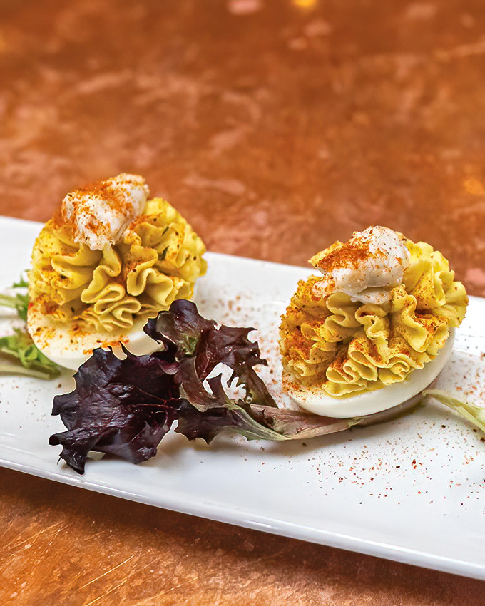 These deviled eggs have dressed for the occasion, wearing their paprika-dusted finery and standing at attention like culinary soldiers.