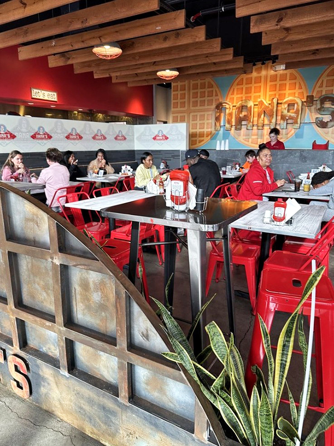 A vibrant dining room where strangers become friends united by the universal language of fantastic food. Red chairs add that perfect pop of energy.