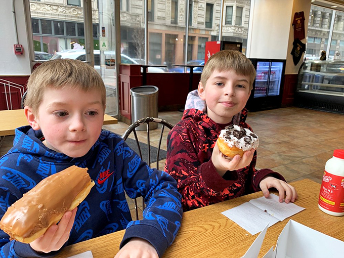 The next generation of donut connoisseurs getting their education early. These expressions say, "We understand something about life that others don't yet."
