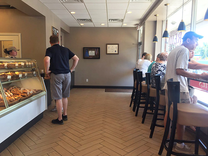 The universal language of pastry appreciation brings people together at the counter, united in their quest for the perfect morning bite.