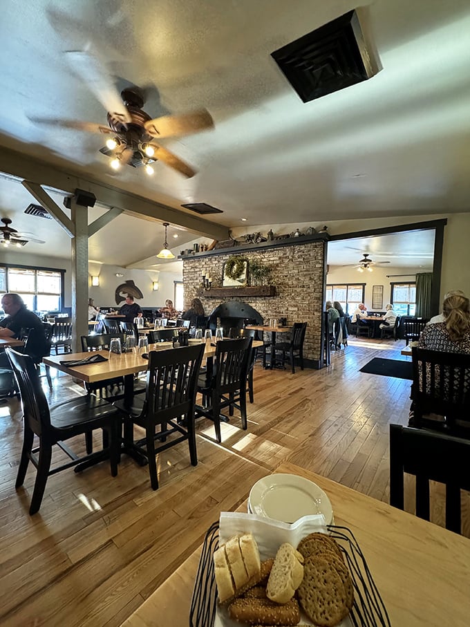 The stone fireplace anchors the room like a culinary lighthouse, while wooden beams overhead remind you of the honest Midwestern craftsmanship that built this place.