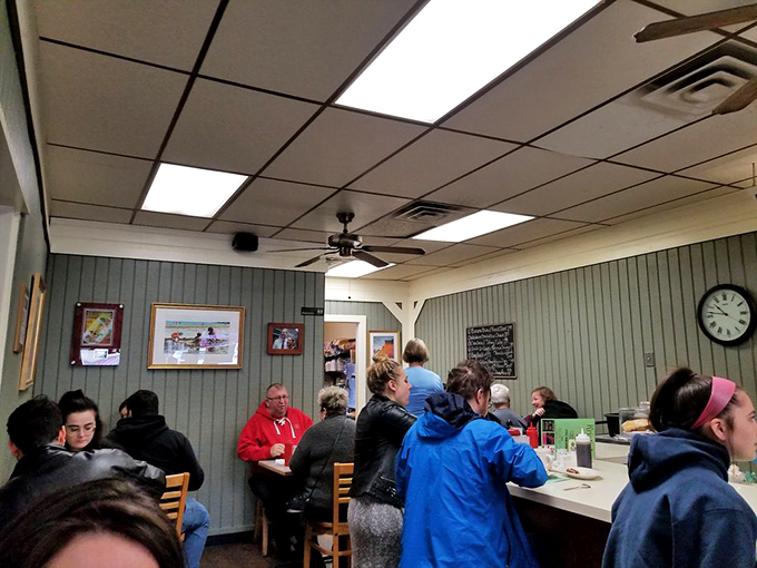The true measure of a breakfast joint: a diverse crowd of locals huddled over steaming plates, all momentarily united in the pursuit of morning perfection.
