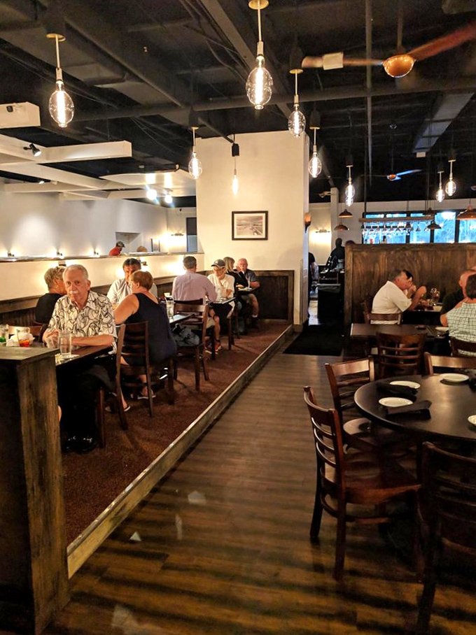 A dining room where Edison bulbs cast the perfect glow for both serious food appreciation and the "remember when" conversations that flow between bites.