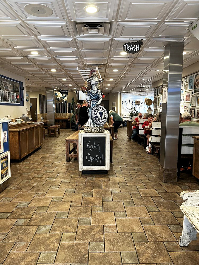 The bustling interior where memories are made, stomachs are filled, and the statue watches over it all like a benevolent Greek guardian.