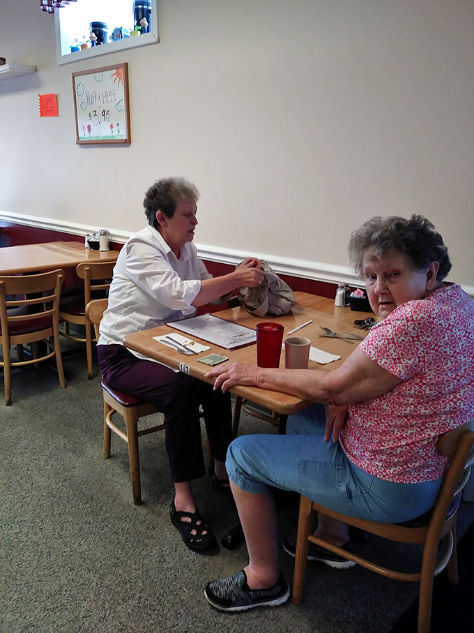 The dining room hums with the energy of regulars who've claimed their favorite tables through years of loyal patronage.