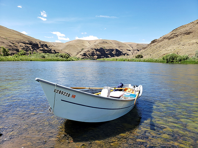 A drift boat waits patiently on crystal waters, promising adventures that can't be downloaded, streamed, or scrolled through.