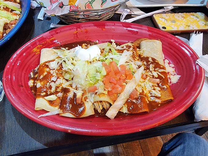 These enchiladas swim in sauce so good you'll be tempted to request a spoon for the leftovers. The sour cream dollop melts like snowflakes in paradise.