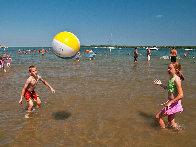 Shallow waters perfect for impromptu beach ball tournaments. Childhood summer memories being made in real-time.