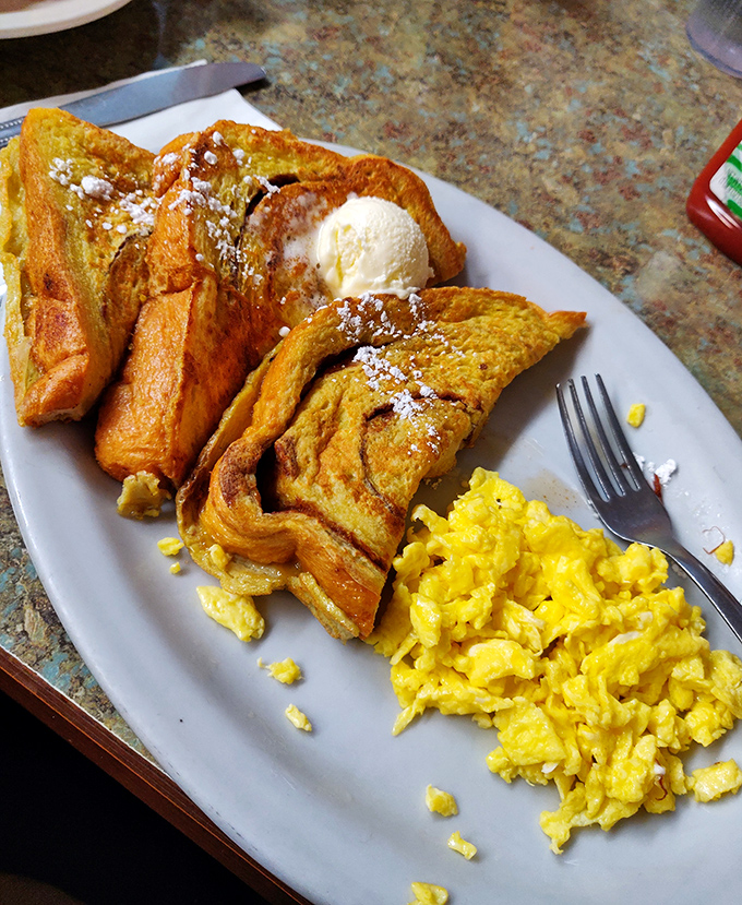 French toast that doesn't need a passport to impress, served with scrambled eggs the color of Idaho sunshine.