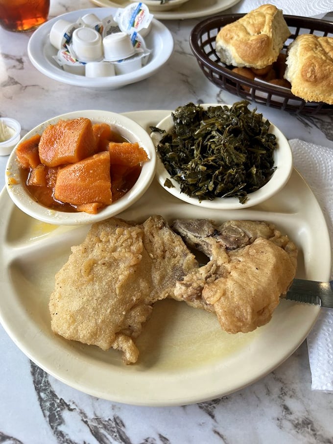 Southern comfort on a plate: golden fried pork chops, tender collards, and candied yams sweet enough to make you speak with an accent.