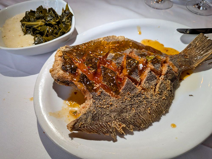 The scored flounder arrives looking like it performed a final, magnificent swan dive directly onto your plate, crispy edges and all.