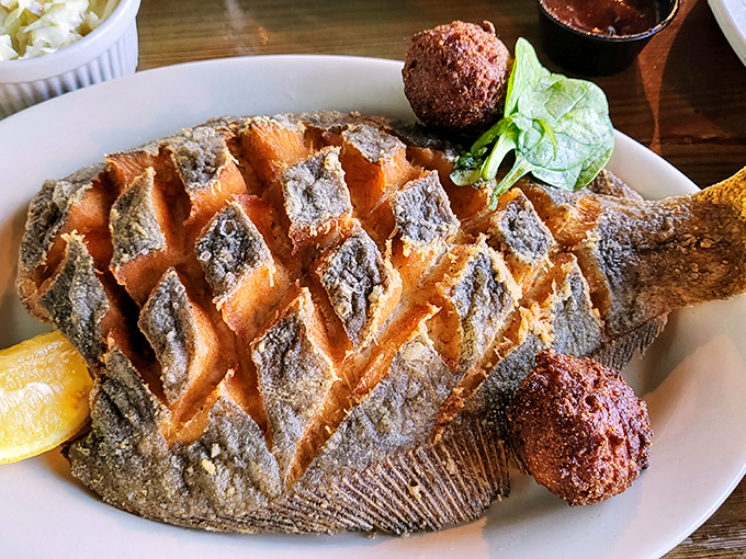This whole fried fish has been scored and fried so perfectly, it looks like it's wearing a delicious golden corset of crispy goodness.