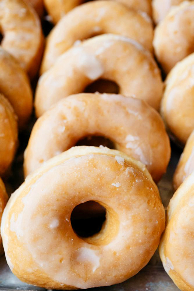 Glazed donuts lined up like sweet soldiers, their shiny tops glistening with promise. Resistance is futile, just accept it.