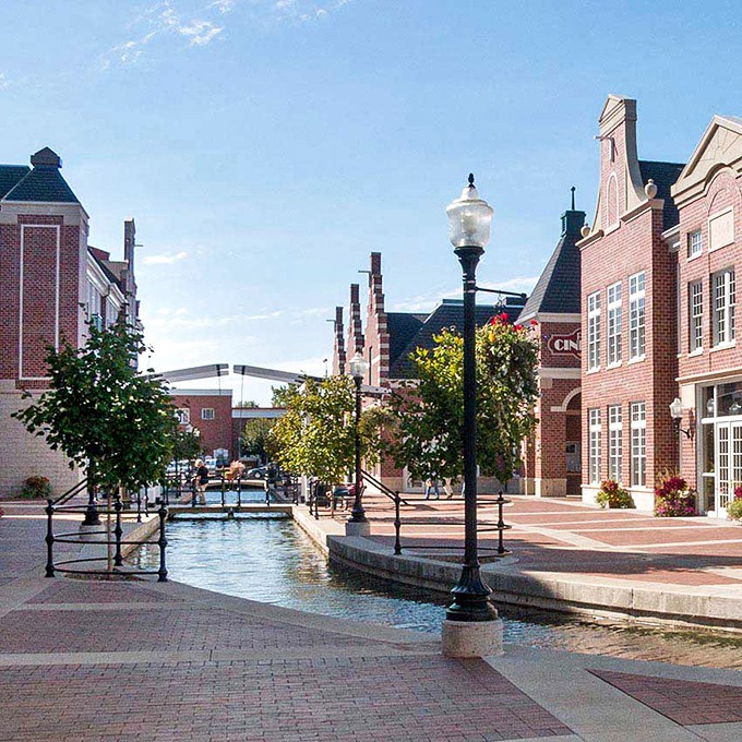 The canal winding through Pella's shopping district proves that water features aren't just for Vegas hotels. This is how you elevate a shopping trip.