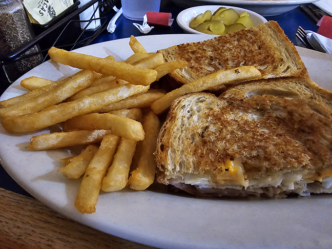 The humble grilled cheese elevated to art form&mdash;golden, buttery, and oozing with melted goodness. Paired with those fries, it's childhood nostalgia with adult appeal.