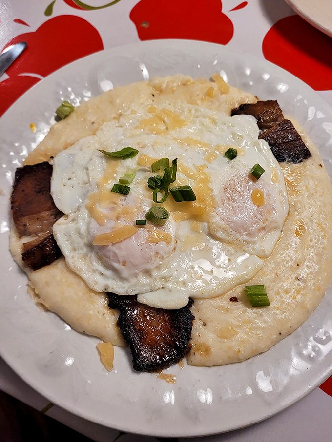 Grits elevated to an art form with perfectly fried eggs and bacon. Southern comfort meets Midwest hospitality on a plate that speaks universal deliciousness.