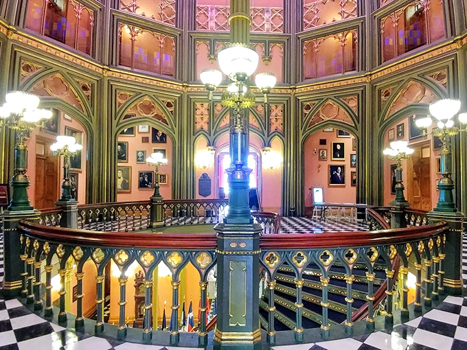Marble busts stand sentinel in this dramatic hallway, where the black-and-white checkered floor gleams like a life-sized chess board.