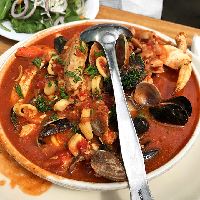 The legendary cioppino: a tomato-based seafood symphony in a bowl. This isn't soup&mdash;it's an edible maritime treasure hunt that requires both spoon and commitment.