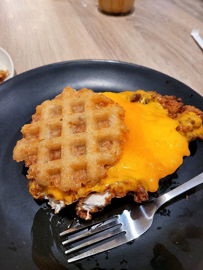 The Mother Clucker sandwich – where fried chicken meets melted cheese in a relationship your cardiologist warned you about.