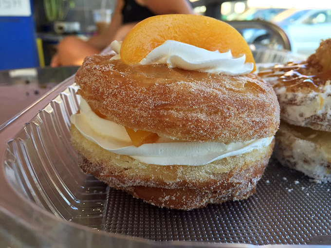 Peaches and cream cronut &ndash; summer's perfect romance captured between layers of pastry. Like a beach sunset you can actually eat.